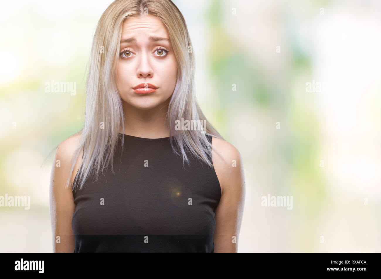 Young blonde woman over isolated background depressed and worry for ...