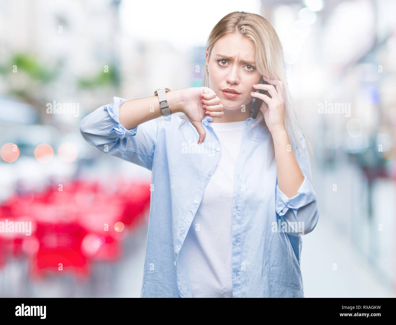 Young blonde woman talking using smarpthone over isolated background ...