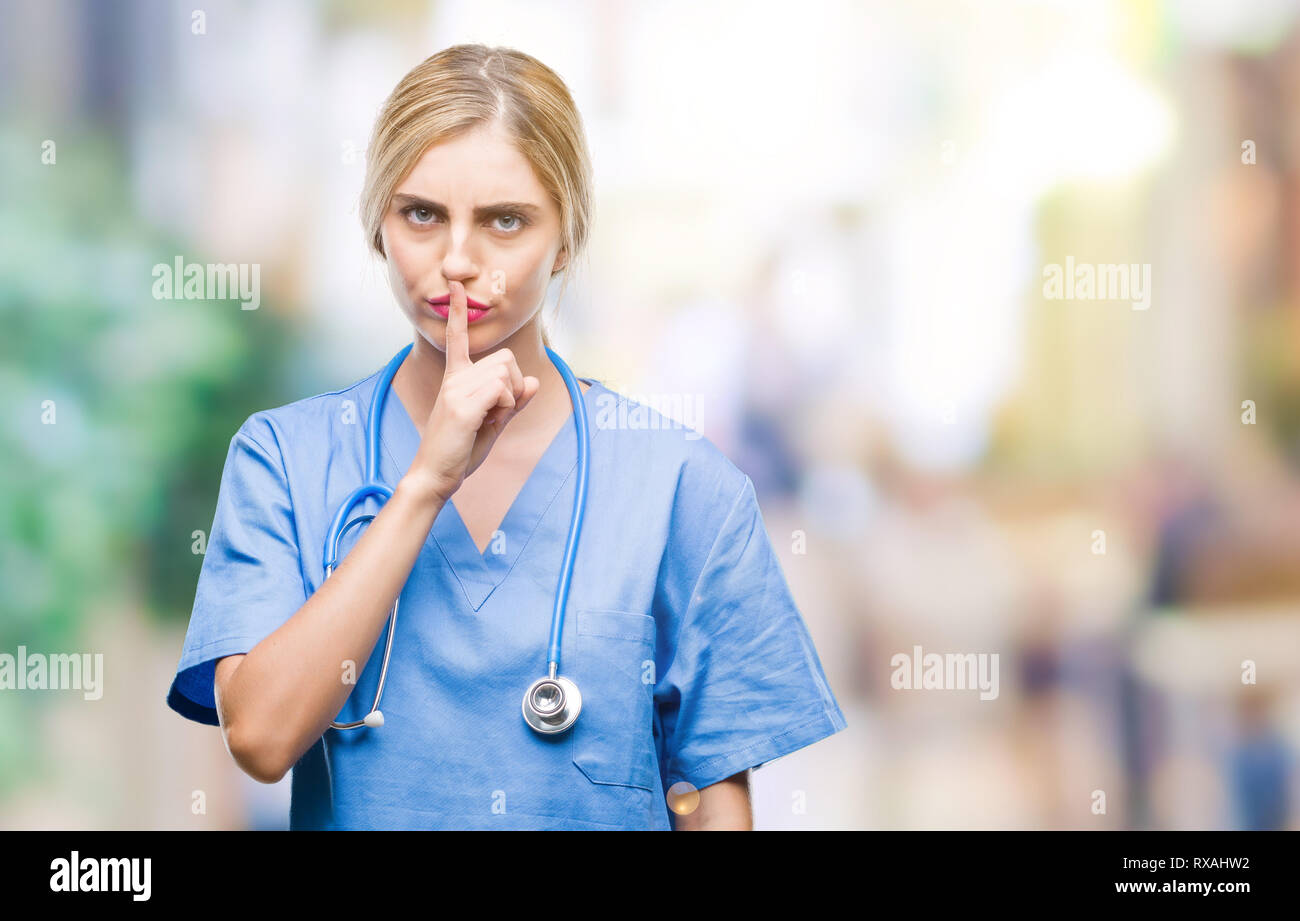 Young beautiful blonde doctor surgeon nurse woman over isolated ...