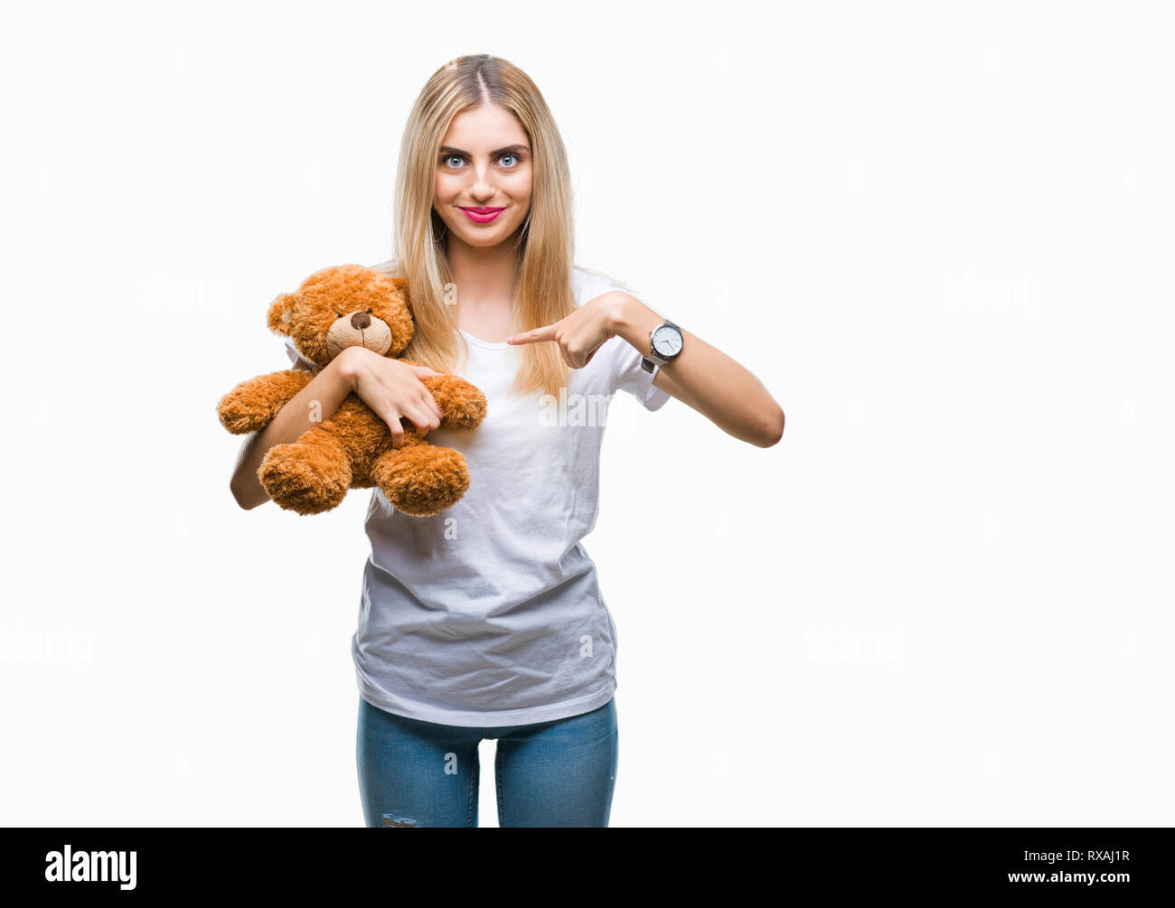 Young beautiful blonde woman holding teddy bear over isolated ...