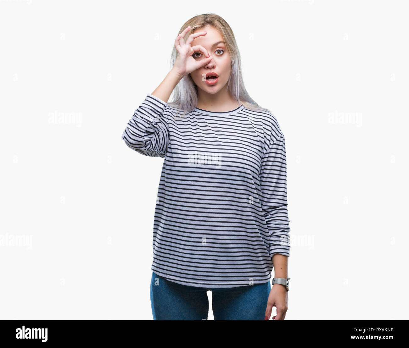 Young blonde woman over isolated background doing ok gesture shocked ...