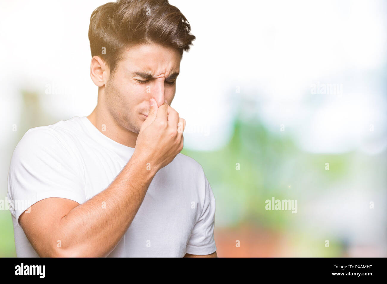 Young handsome man wearing white t-shirt over isolated background ...