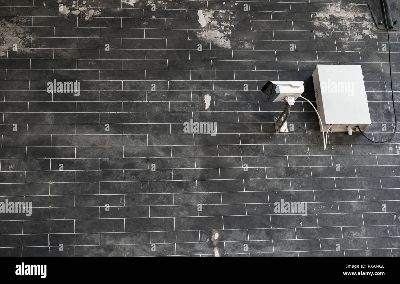 CCTV camera on a wall of an old building Stock Photo - Alamy