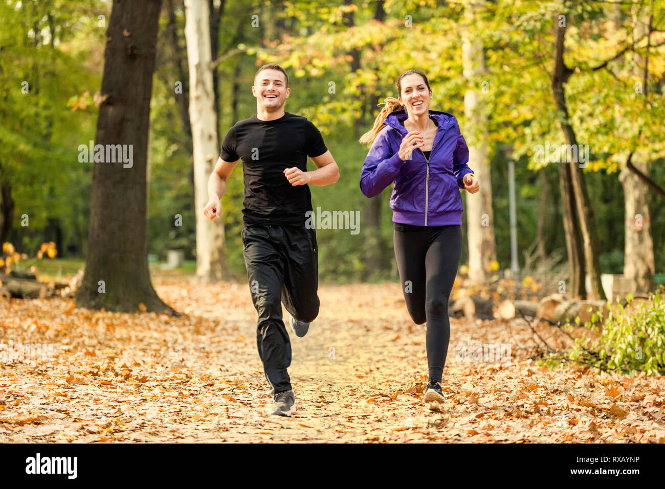 Cheerful people jogging in park hi-res stock photography and images - Alamy
