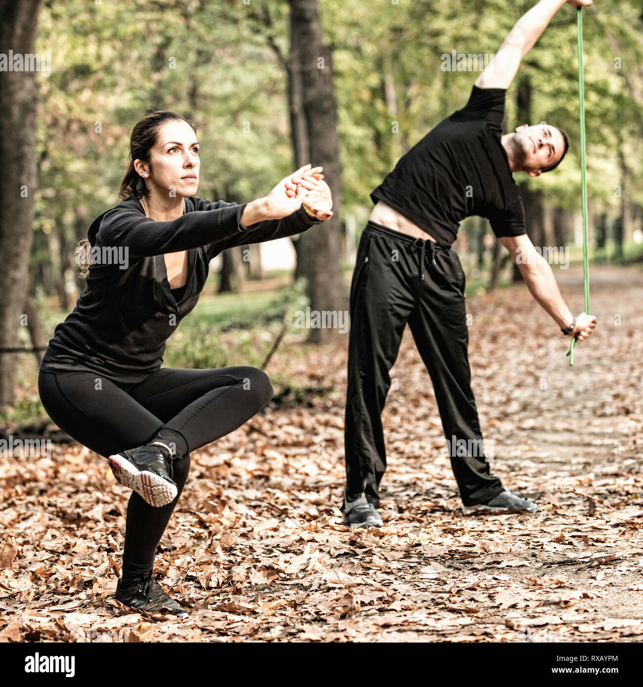 Couple exercising in park Stock Photo - Alamy