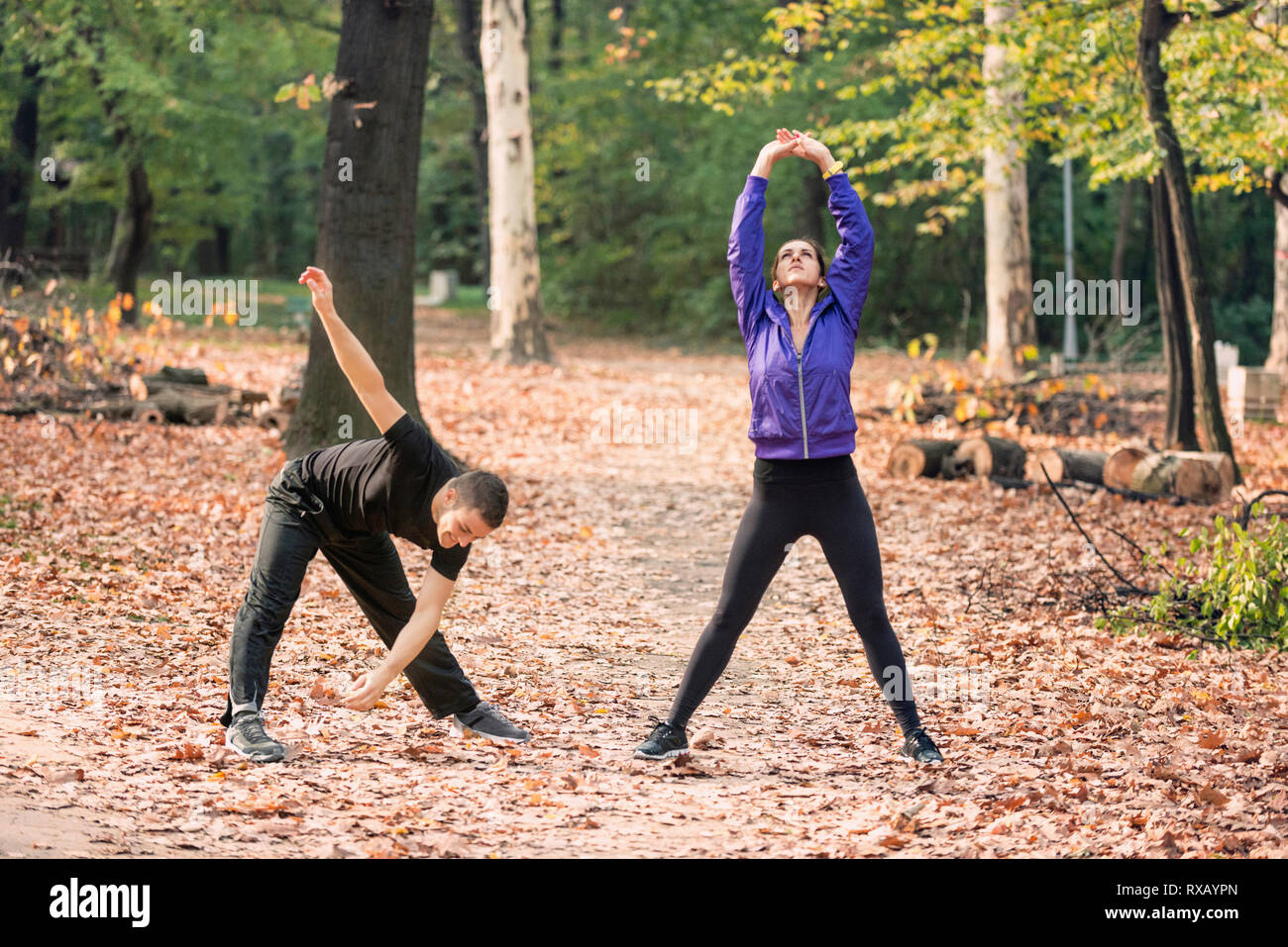 Couple exercising in park Stock Photo - Alamy