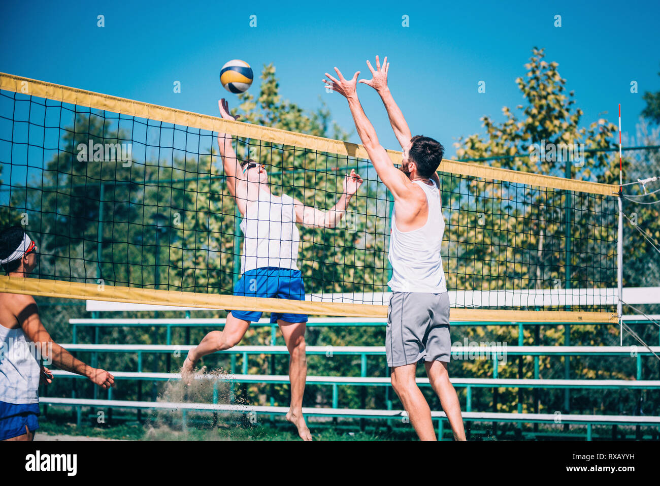 Beach volleyball players at the net Stock Photo - Alamy