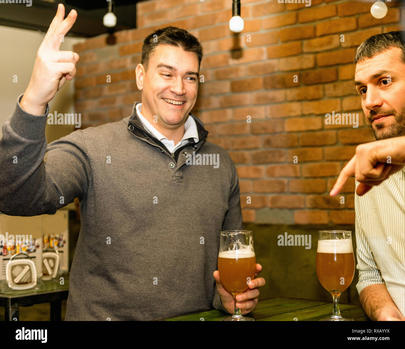Friends drinking beer in a pub Stock Photo - Alamy