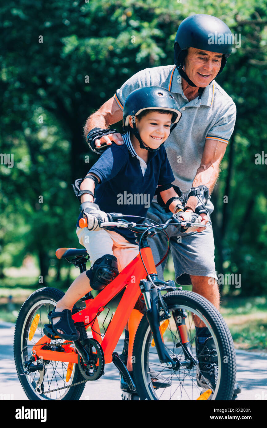 Learning how to ride a bike Stock Photo - Alamy