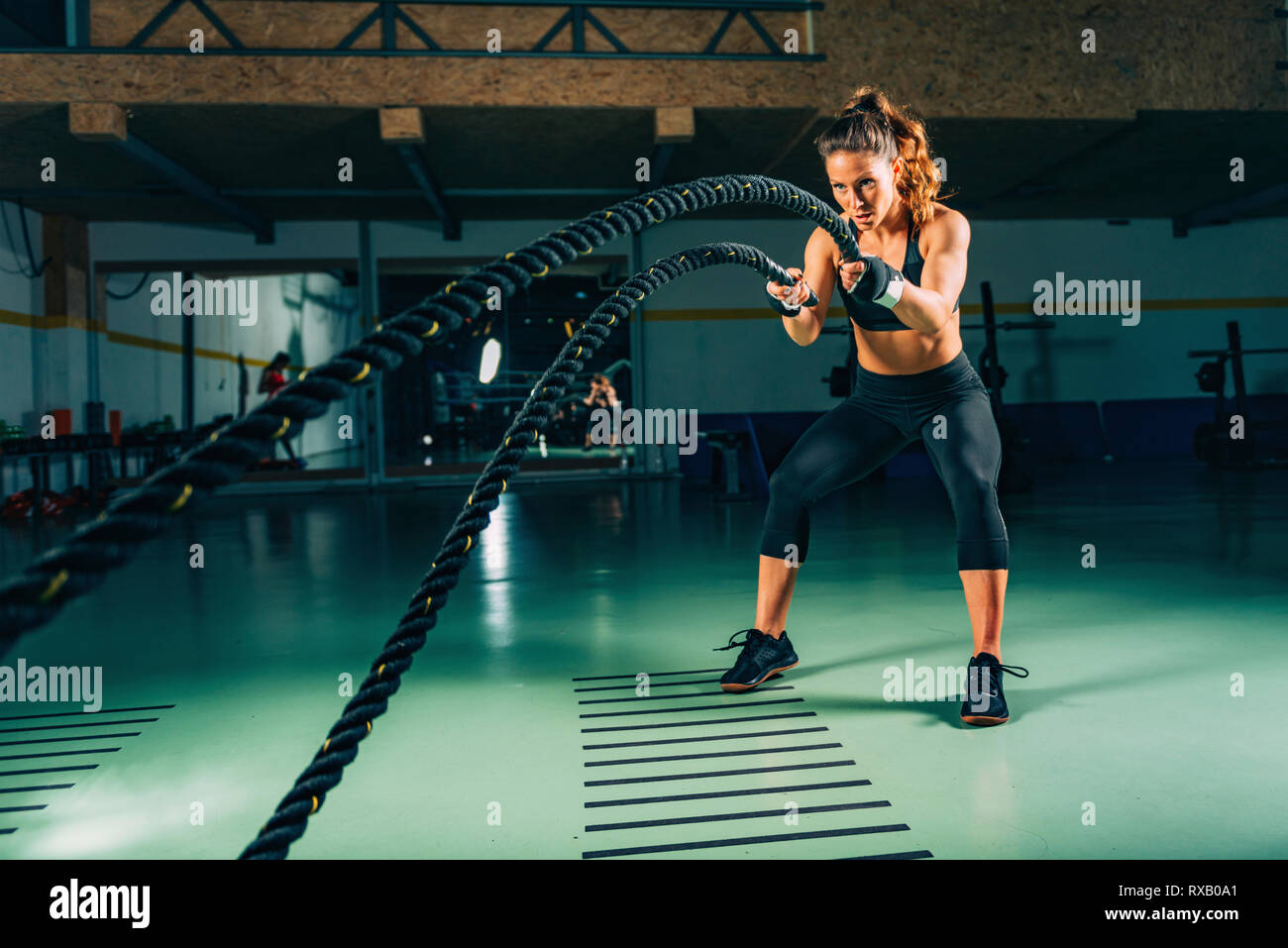Gym swinging battle ropes hi-res stock photography and images - Alamy