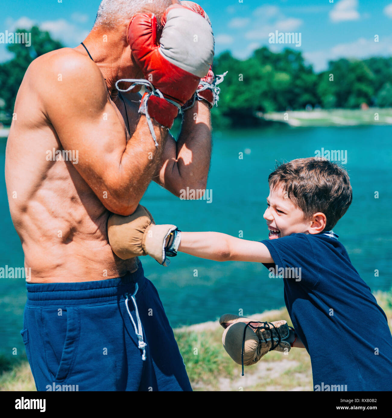 Grandfather and grandson boxing Stock Photo - Alamy