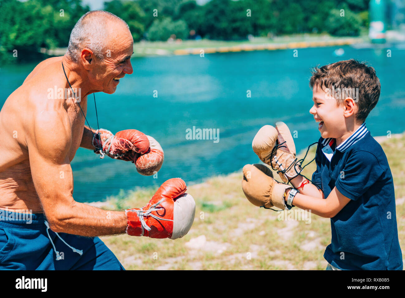 Grandfather and grandson boxing Stock Photo - Alamy