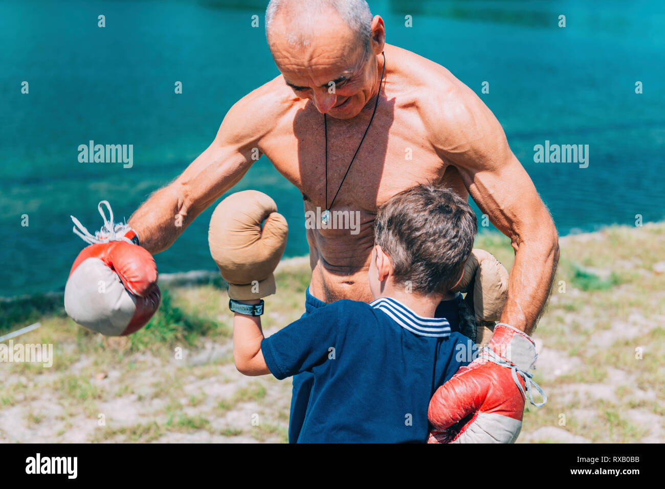 Grandfather and grandson boxing Stock Photo - Alamy