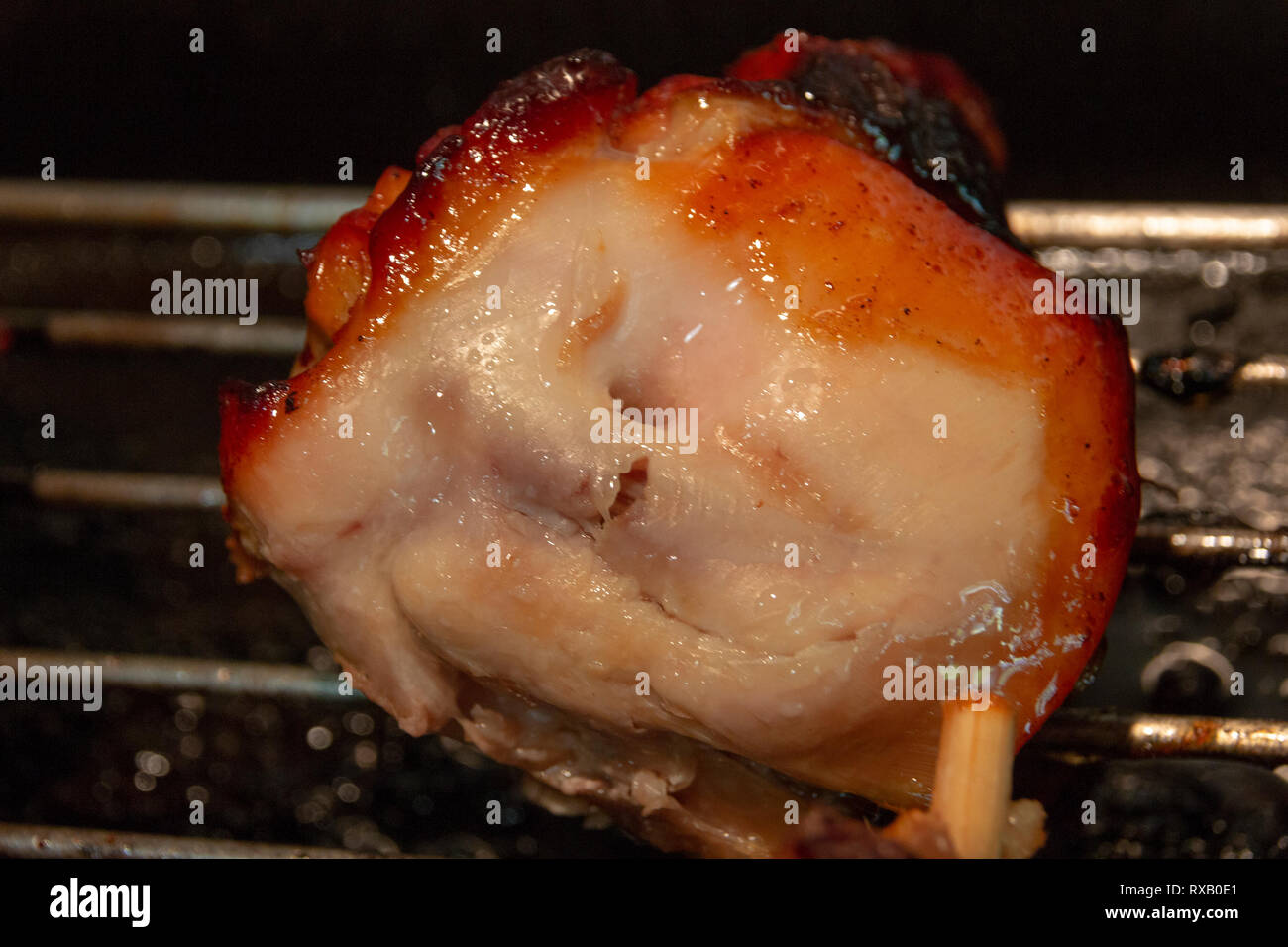 A close up view of part of cooked pieces of chicken put together on a ...