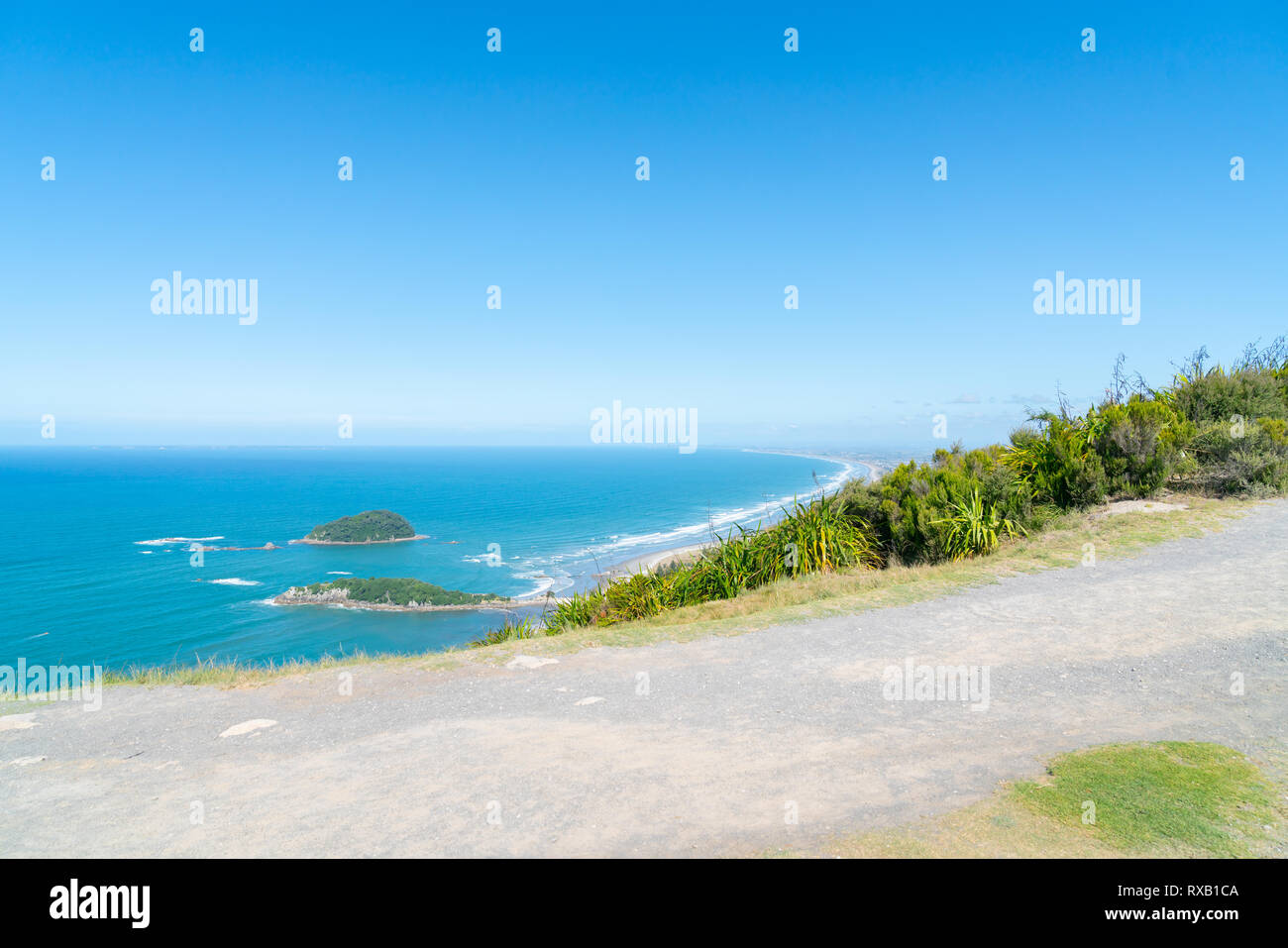 Summit track and beaches and sea stretching to horizon below viewed ...