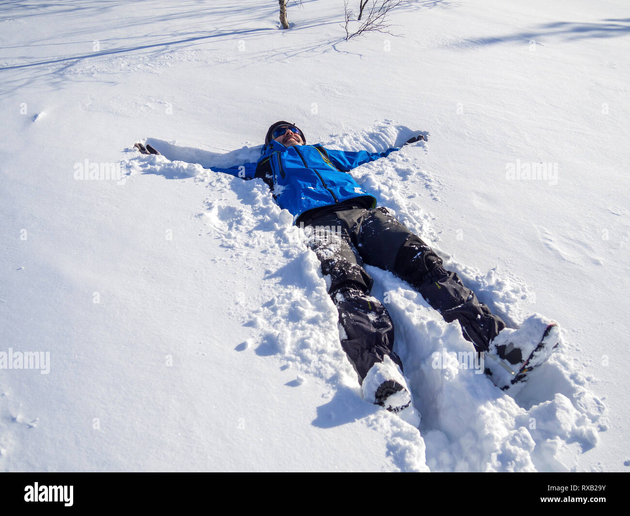 Man lying on snow in hi-res stock photography and images - Alamy