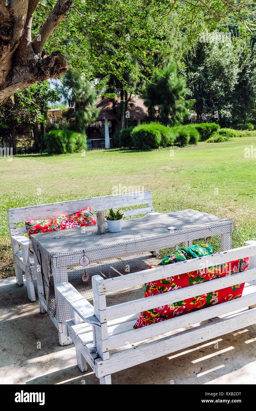 Image of Empty table in the house's garden Stock Photo - Alamy