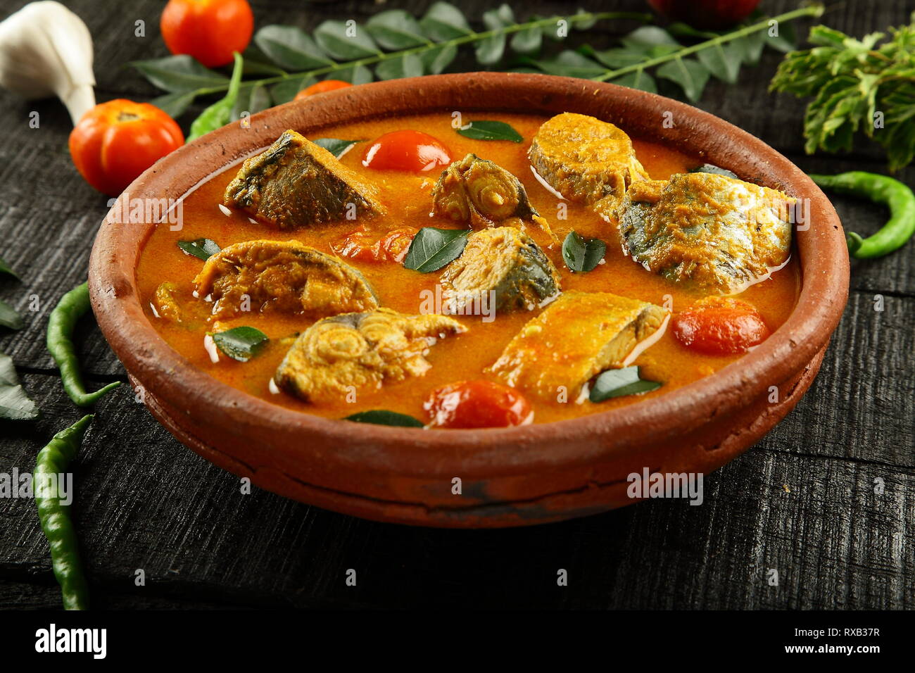 Tasty spicy fish curry cooked in clay pottery. Kerala recipes Stock ...