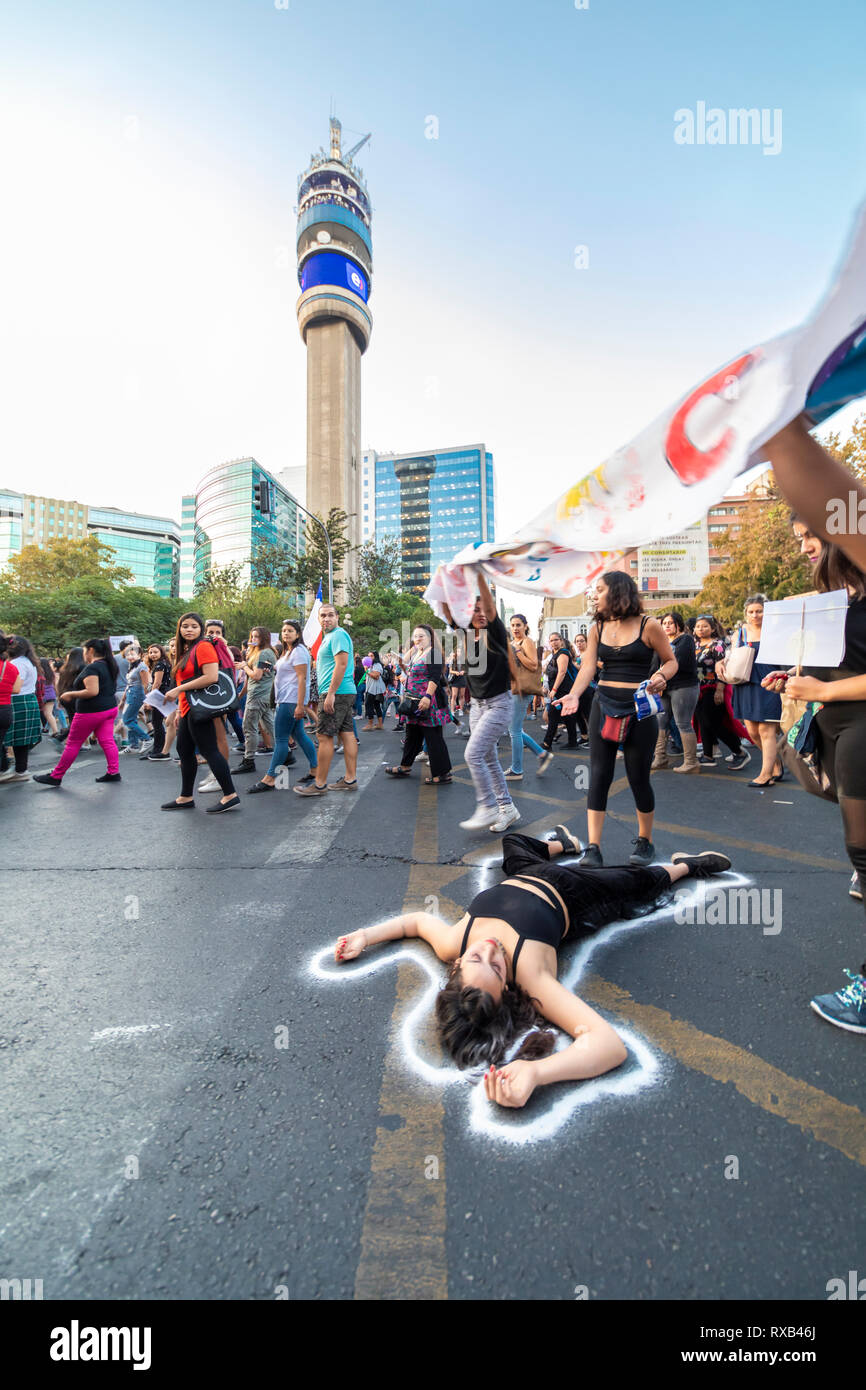 Girl protester lying on the street asphalt at International Women's Day ...