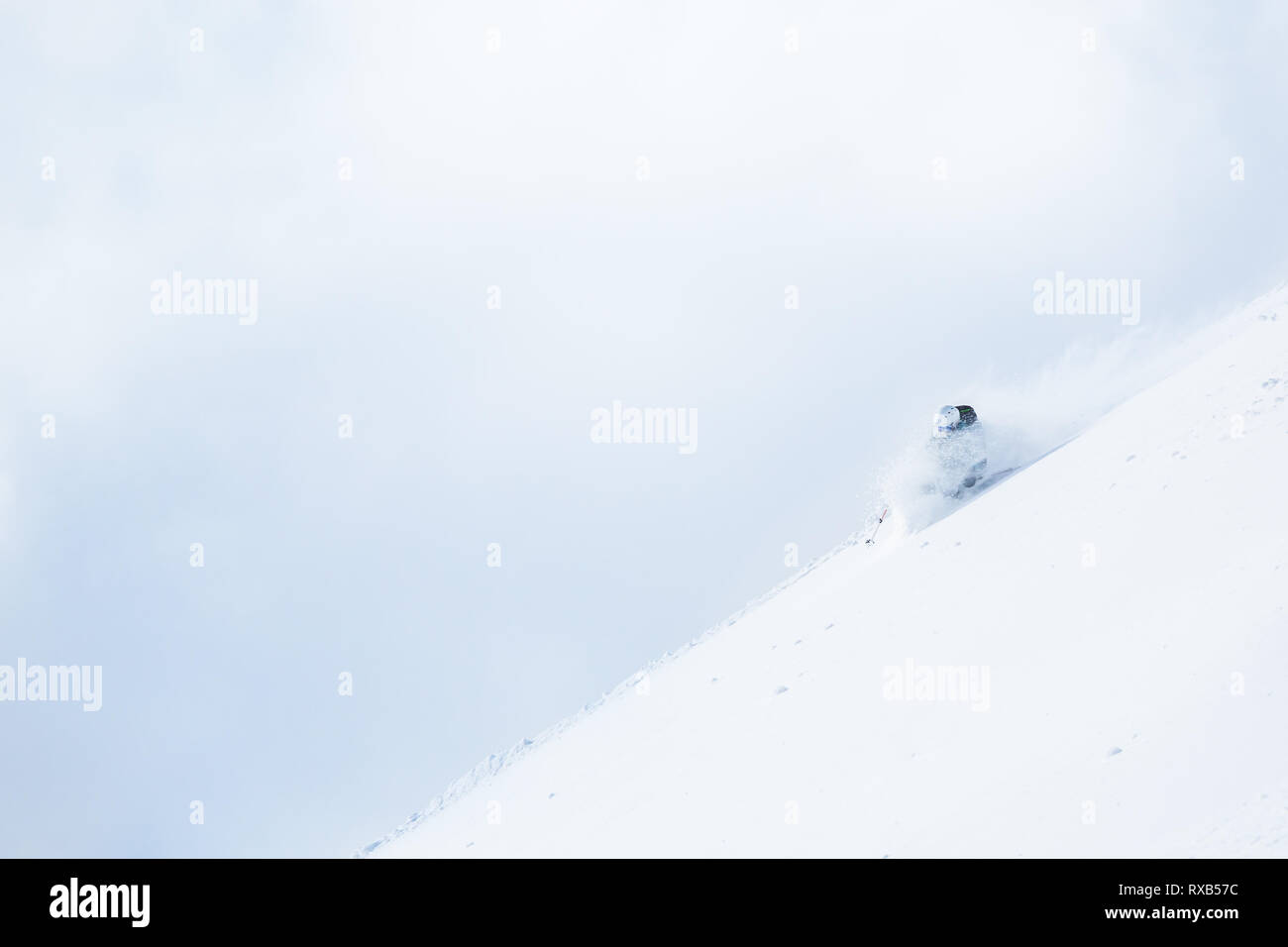 Female skier turning through deep powder on telemark skis in the ...