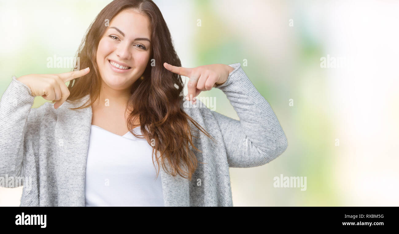 Beautiful plus size young woman wearing winter jacket over isolated ...