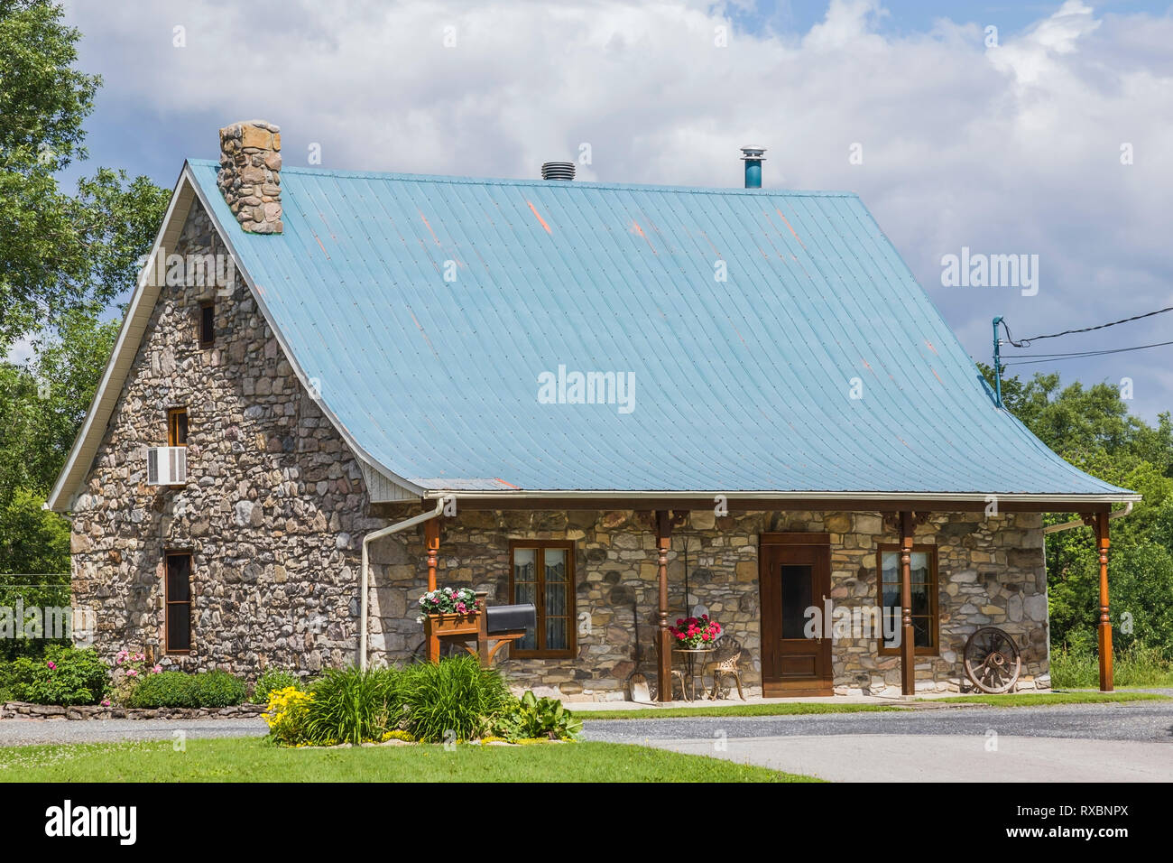 Old 1807 river fieldstone cottage style house facade in summer hi-res ...