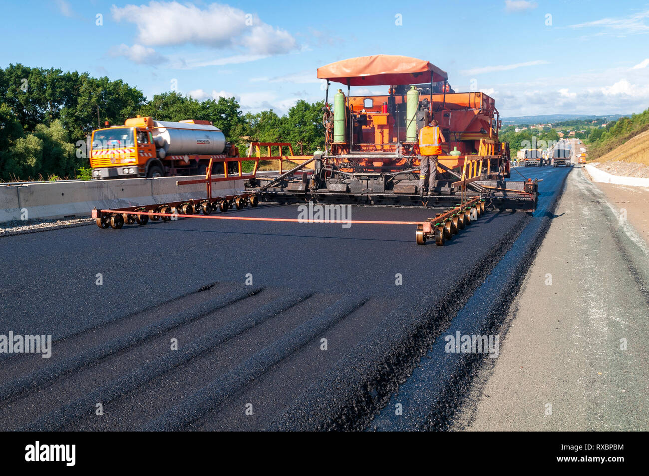 Rear view of a paver, paver screed and control system. Foreground ...