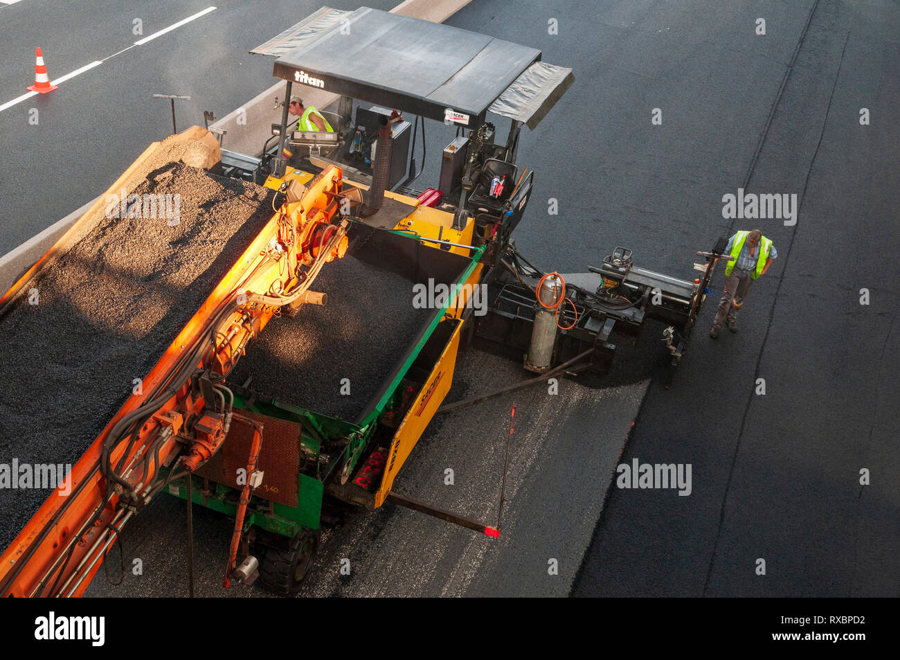 Conveyor belt feeding hopper of a paver Stock Photo - Alamy