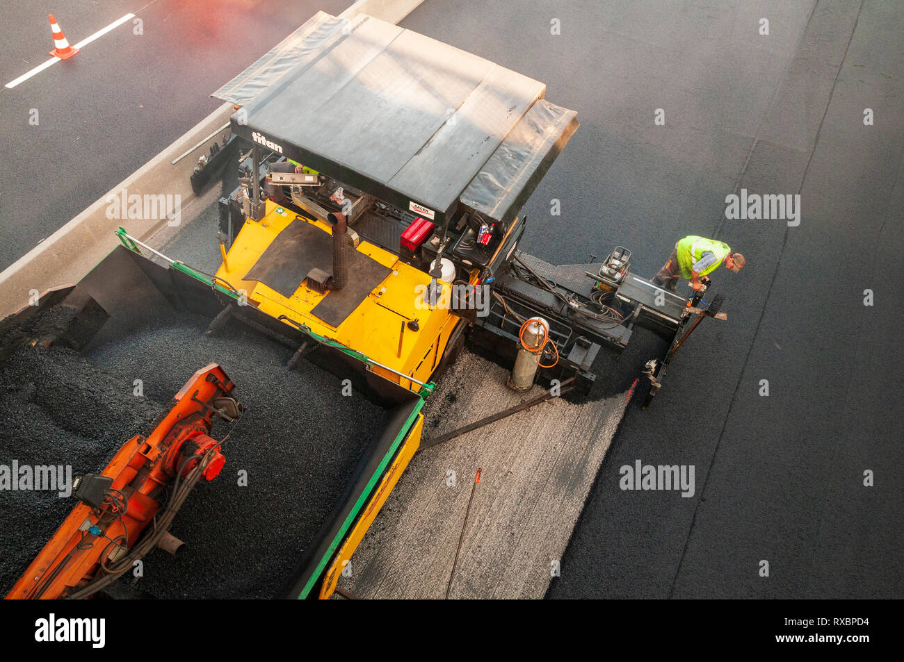 Filling the hopper of a paver Stock Photo - Alamy