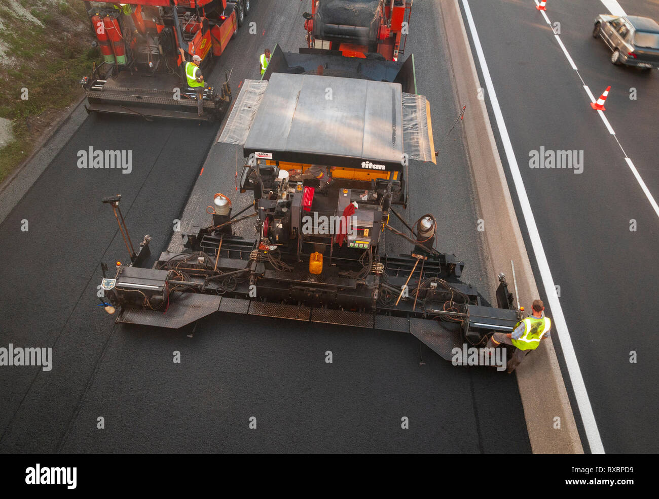 Asphalt application on an express road. Two pavers in action . top view ...