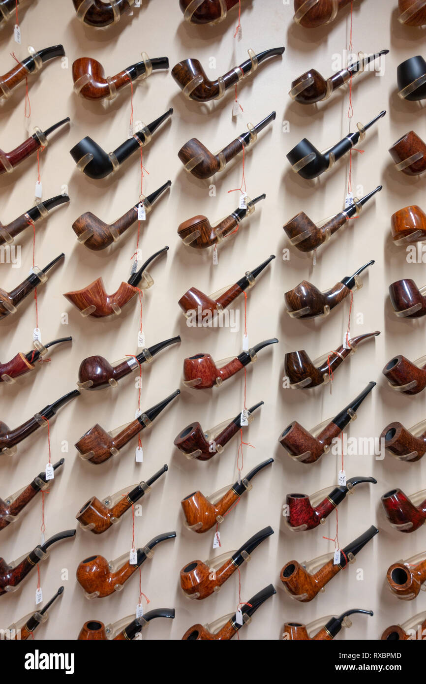 many tobacco pipes are hanging on a wall in a tobacco shop Stock Photo ...