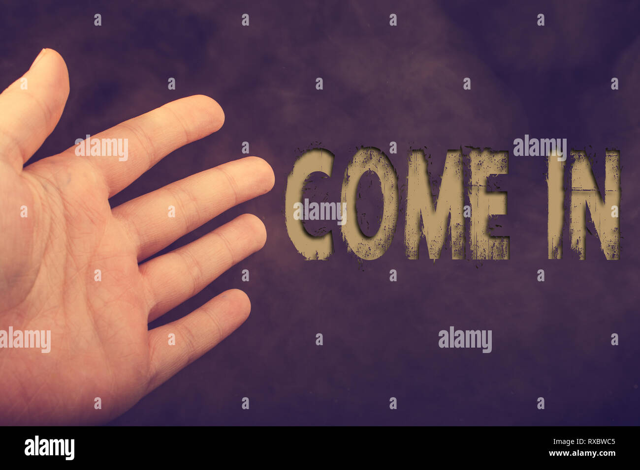 Hand making welcome gesture saying come in Stock Photo - Alamy