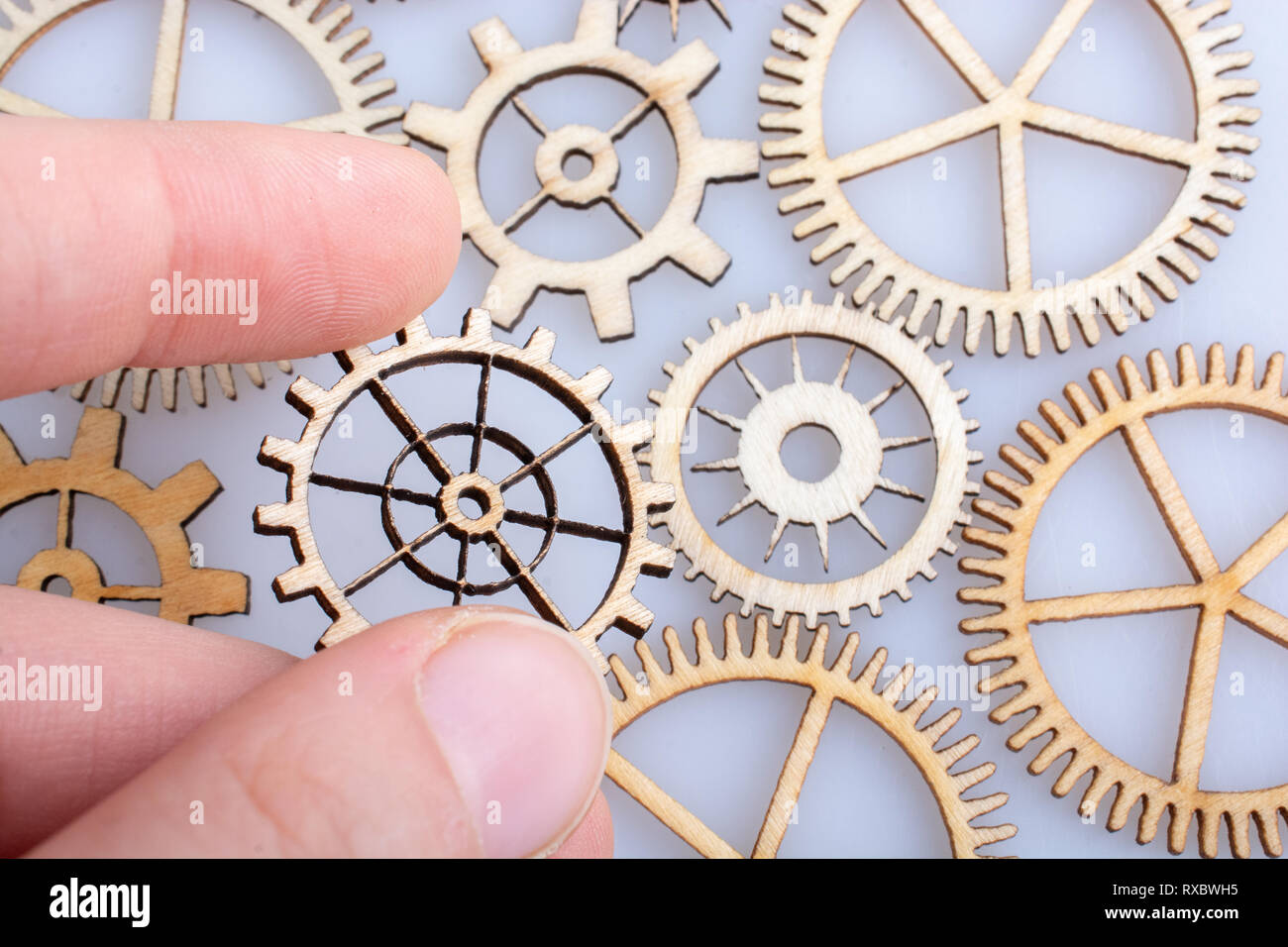 Hand holding gear wheels as the concept of mechanism Stock Photo - Alamy