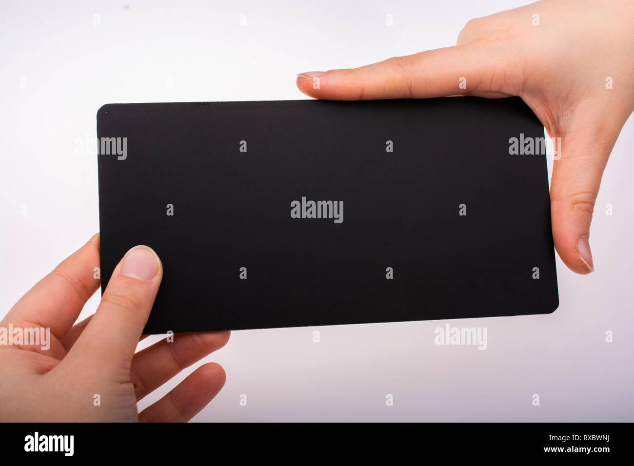 Black speech bubble shaped notice board in hand on white background ...