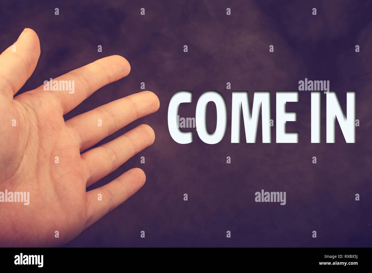 Hand making welcome gesture saying come in Stock Photo - Alamy