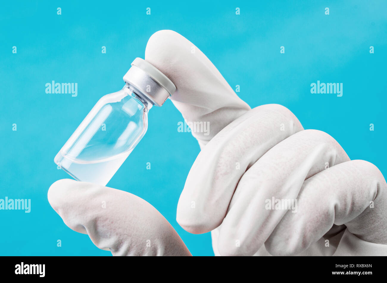 Medicine bottle for injection in hand with white glove. Medical glass ...
