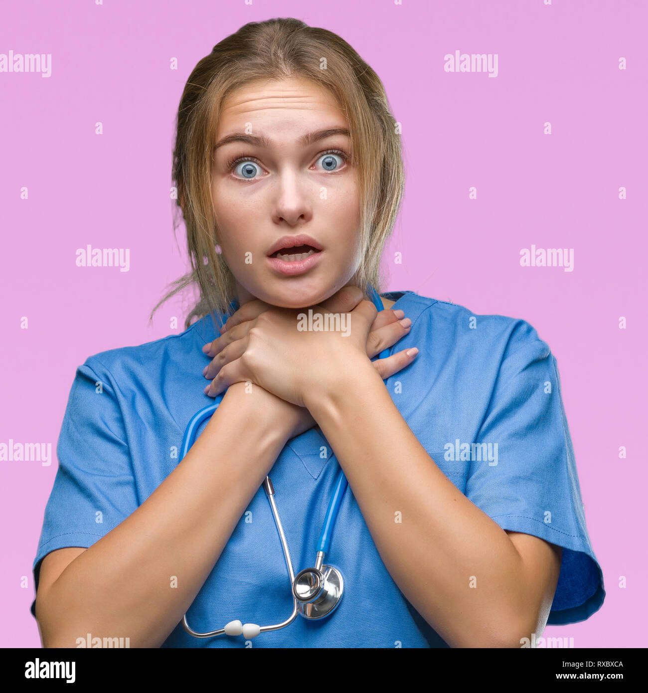Young caucasian doctor woman wearing surgeon uniform over isolated ...