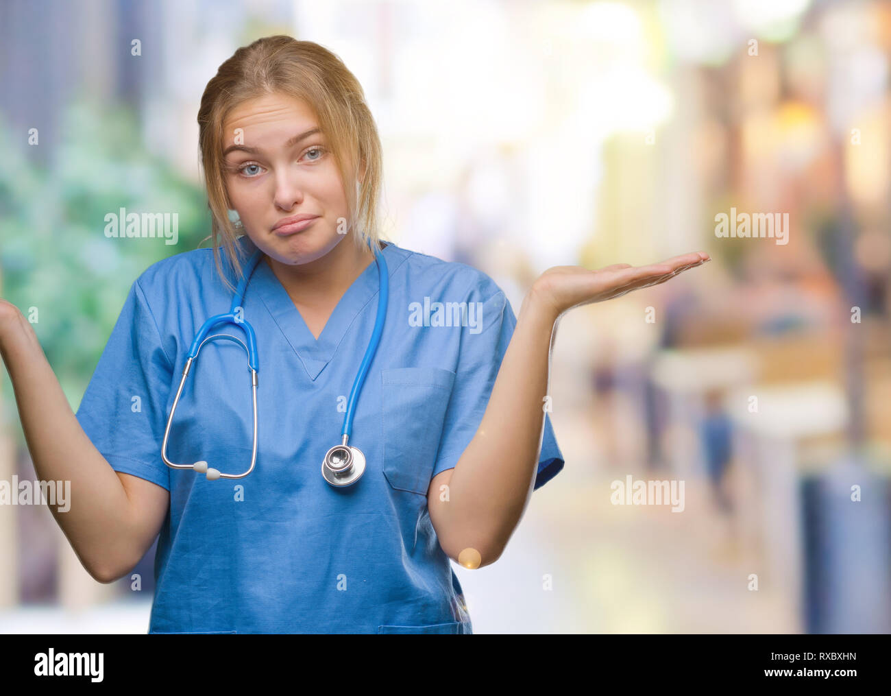 Young caucasian doctor woman wearing surgeon uniform over isolated ...