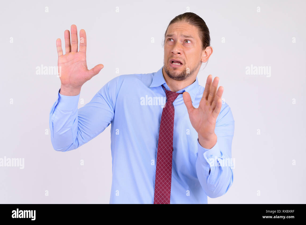 Portrait of shocked businessman looking scared with arms raised Stock ...