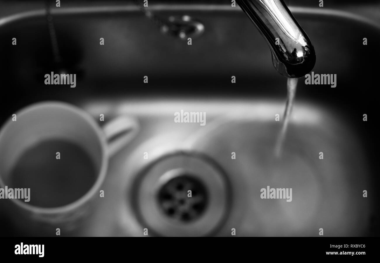 Sink with running tap Stock Photo - Alamy