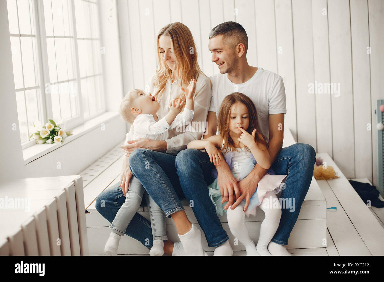 Cute and big family sitting at home Stock Photo - Alamy
