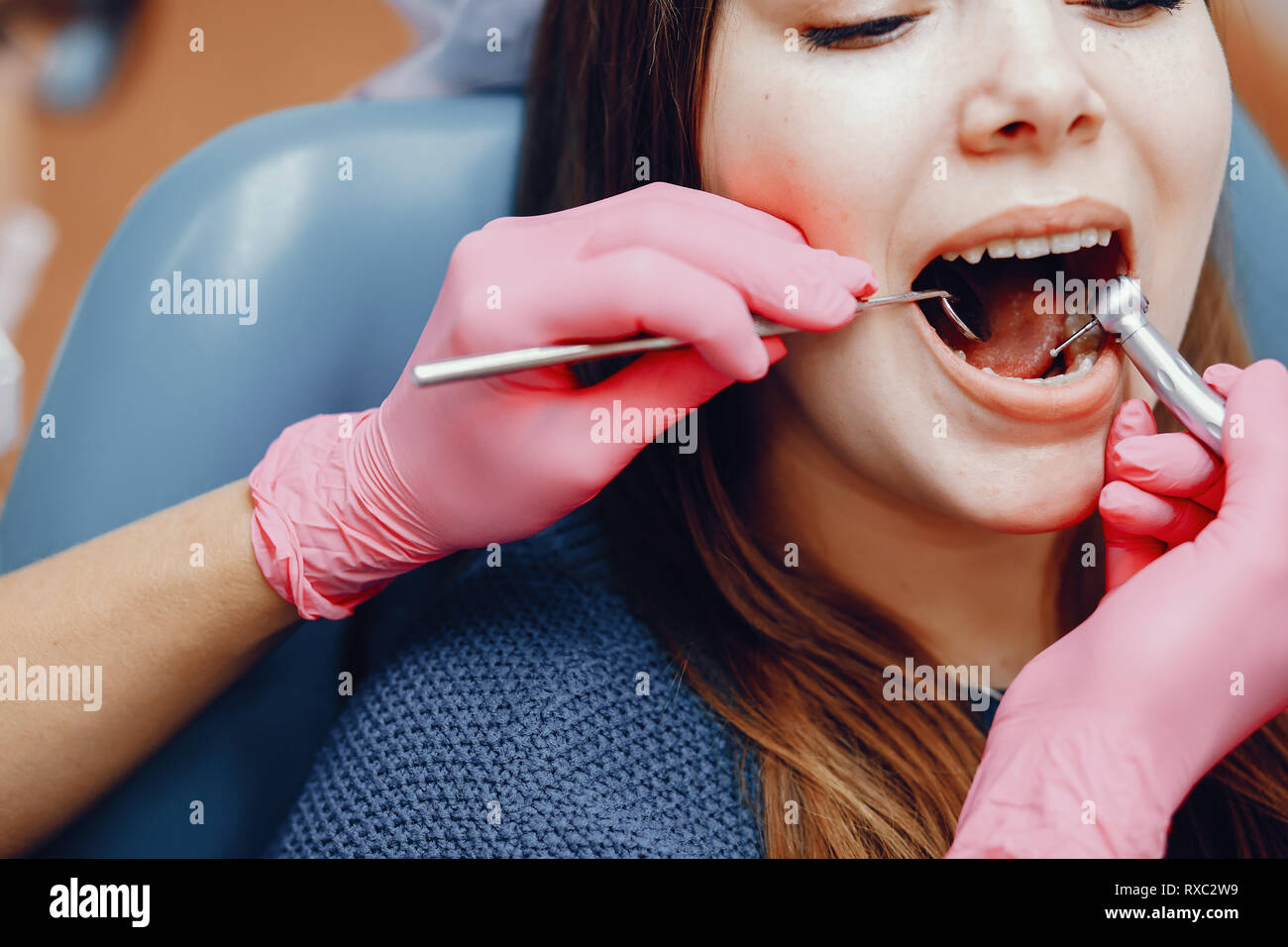 Beautiful girl sitting in the dentist's office Stock Photo - Alamy