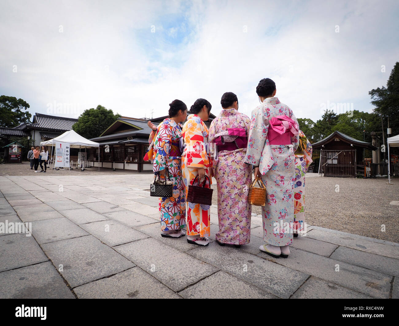A group of female tourists wearing the traditional Japanese kimono ...