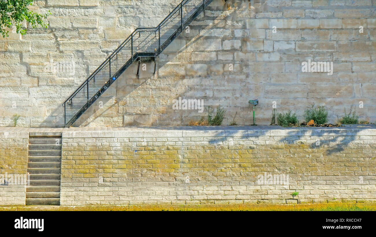A ladder going up to a building in Paris. A long thin ladder located on ...