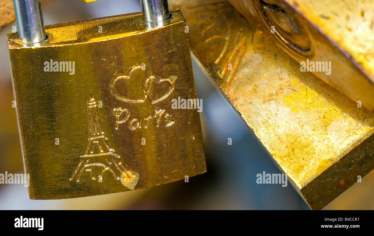 A padlock with a carved of Eiffel tower and Paris. This is locked on ...