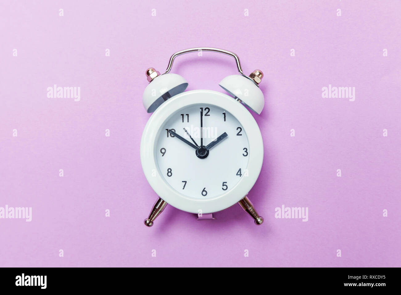 Ringing twin bell vintage classic alarm clock Isolated on purple violet ...