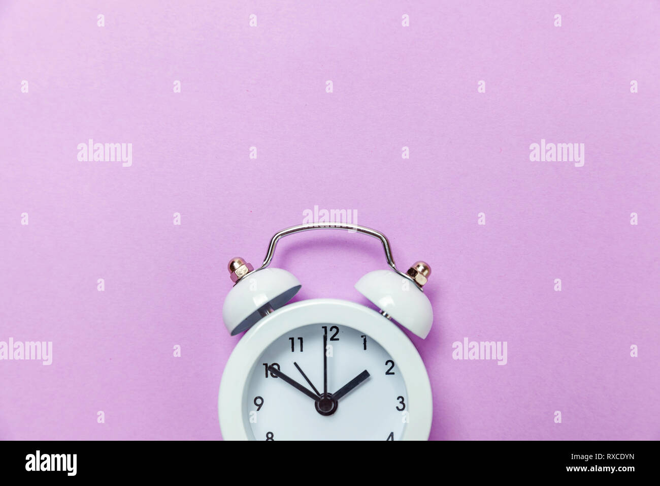 Ringing twin bell vintage classic alarm clock Isolated on purple violet ...