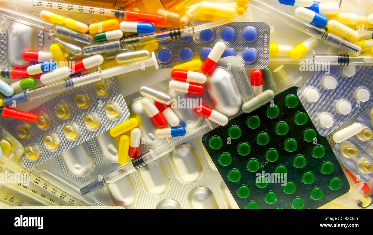 Different kinds of medicines on the glass cabinet. There are capsules ...