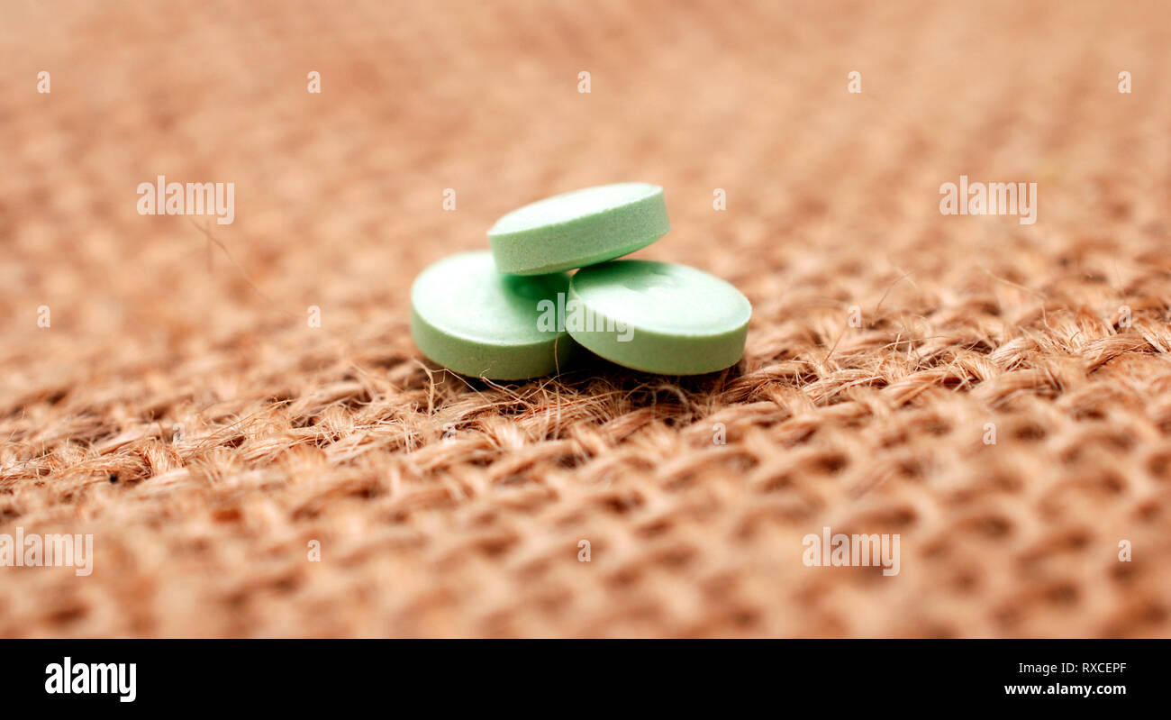 green antidepressant pills on small jute bag background image Stock ...