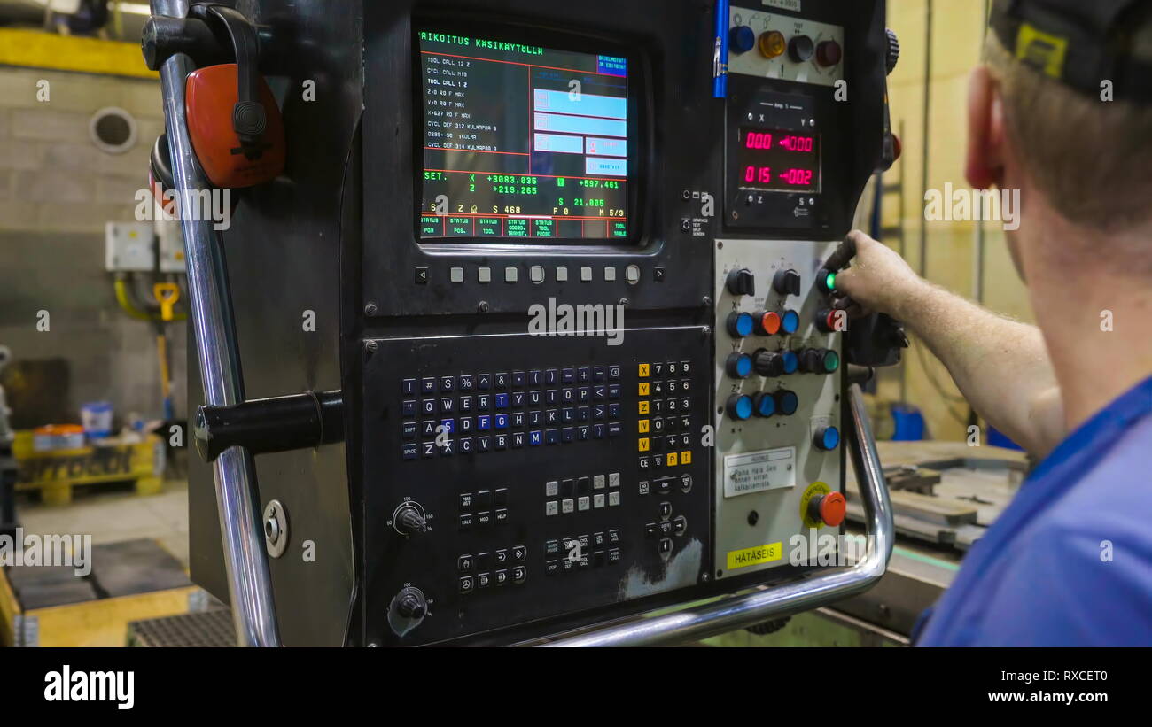 A worker checking on the monitor while processing the metals on the ...
